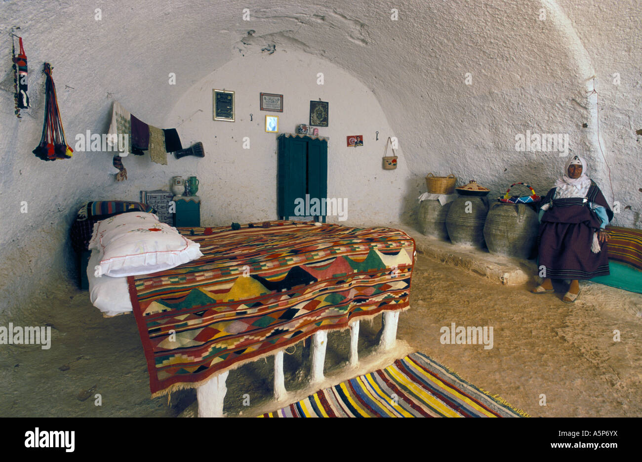 Berber woman in bedroom of Berber troglodyte underground homestead ...
