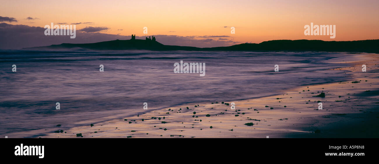 Dawn Dunstanburgh castle from beach Embleton Northumberland England ...