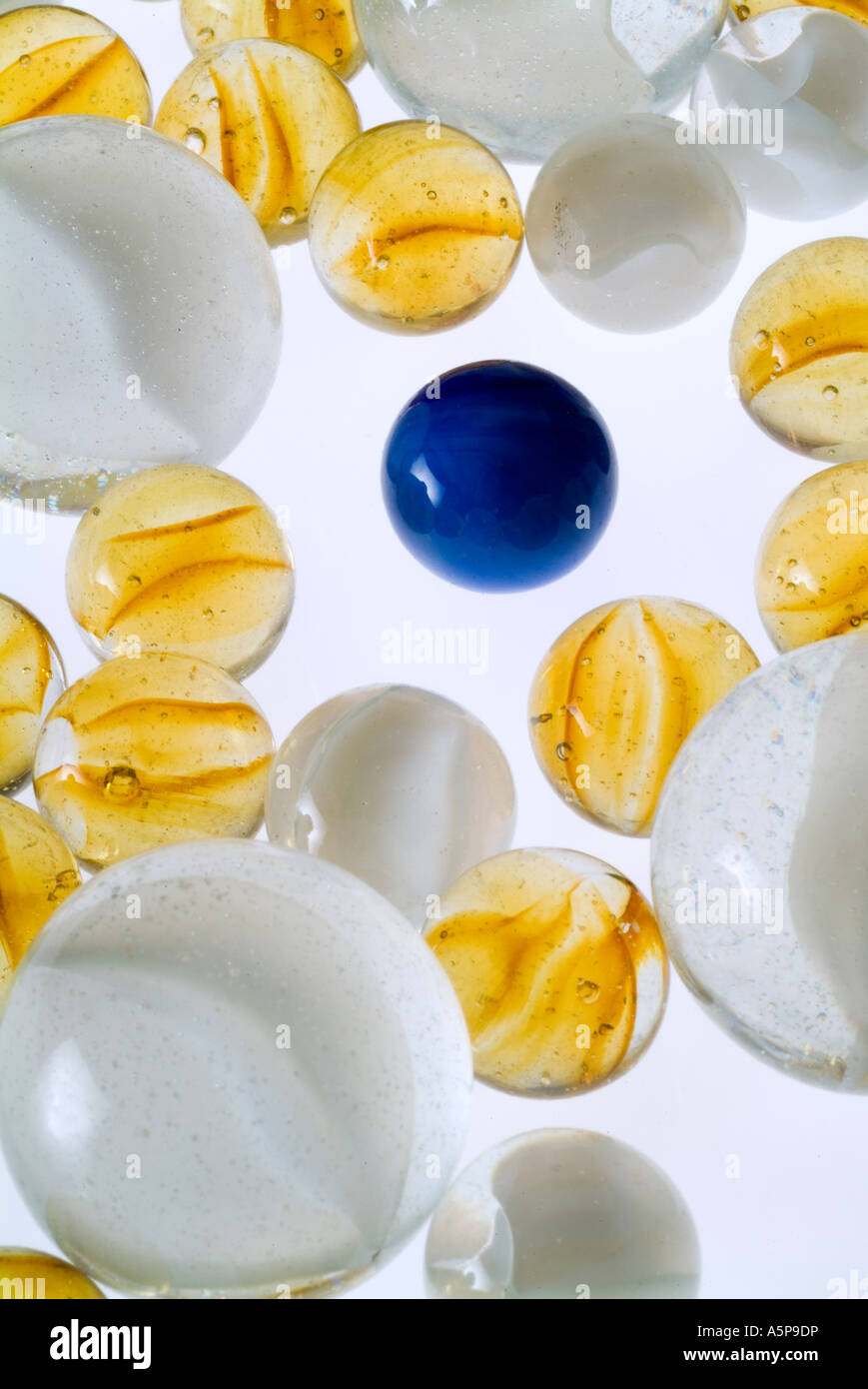 Group of marbles with single blue marble in center Stock Photo - Alamy