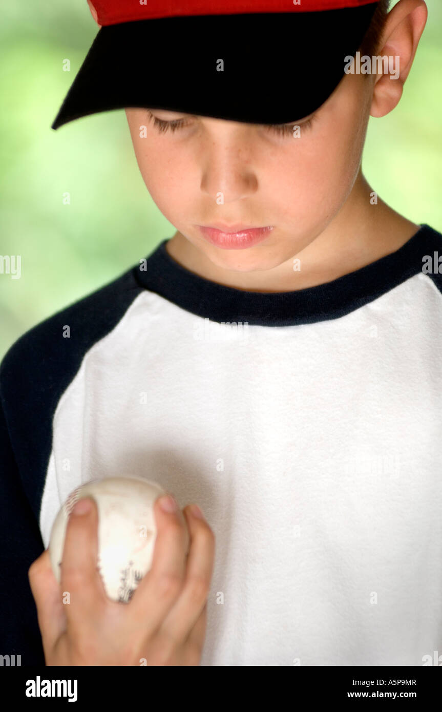 Young boy looking at baseball Stock Photo - Alamy