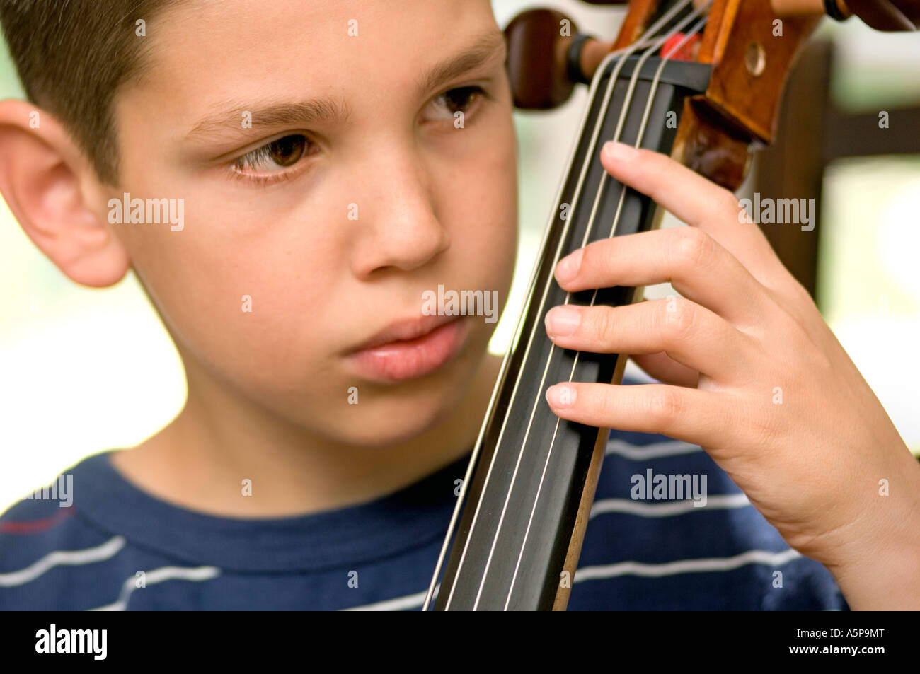 Boy playing cello hi-res stock photography and images - Alamy