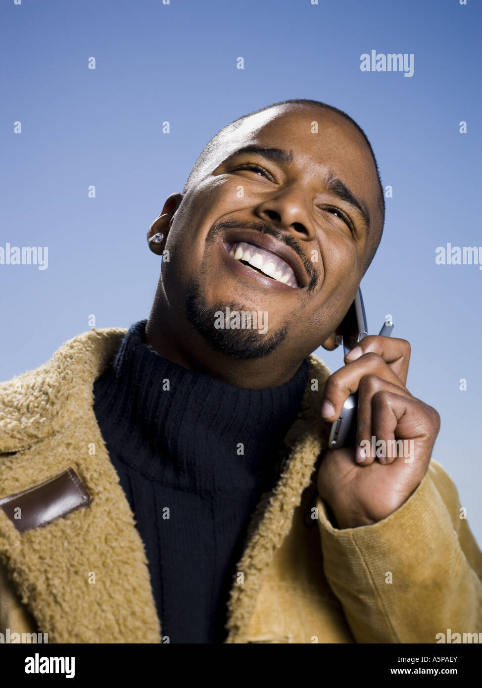 African American man smiling and talking on cell phone Stock Photo - Alamy