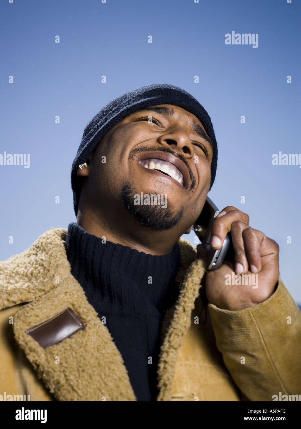 African American man smiling and talking on cell phone Stock Photo - Alamy