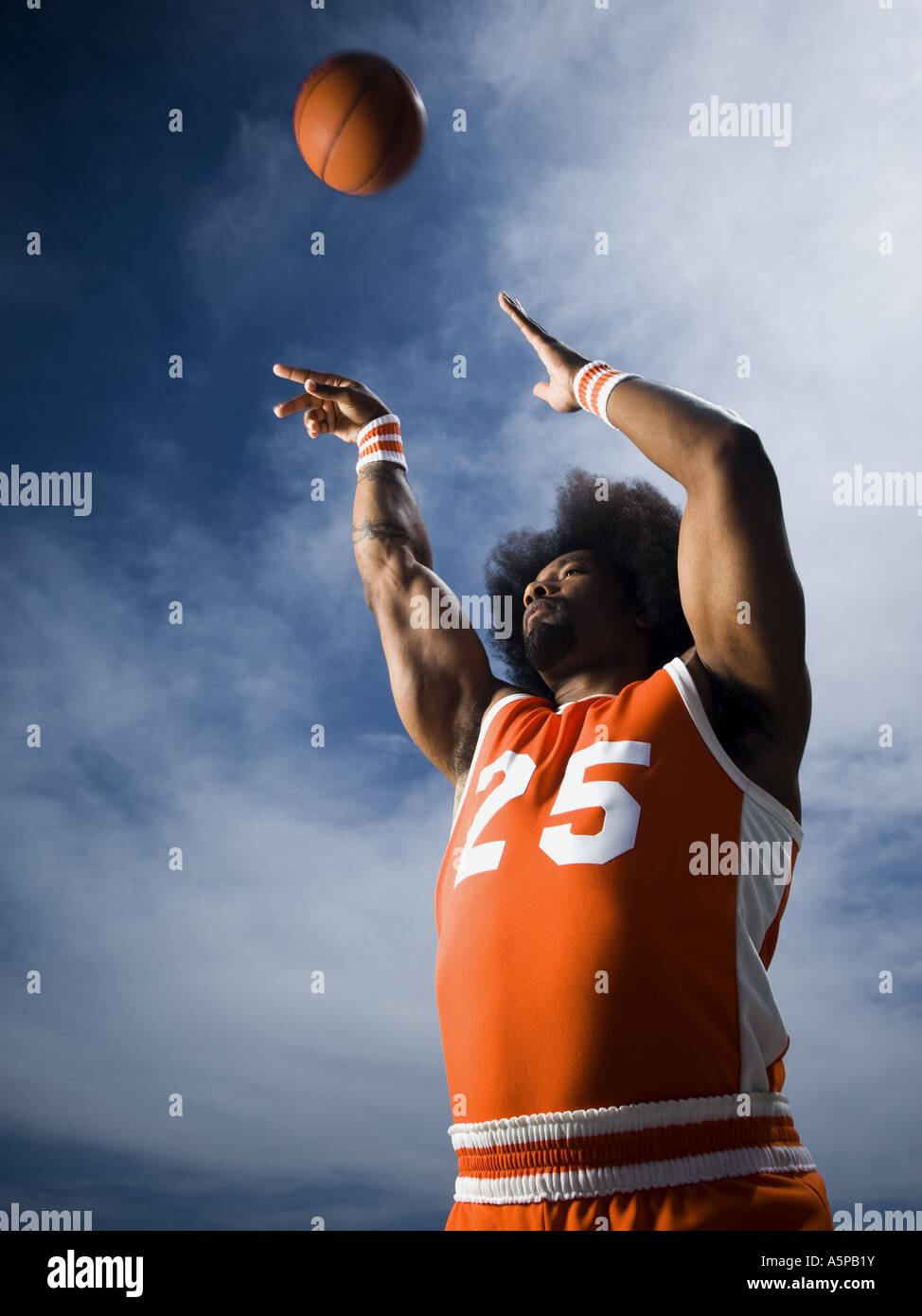 Basketball player with an afro in orange uniform taking shot Stock ...