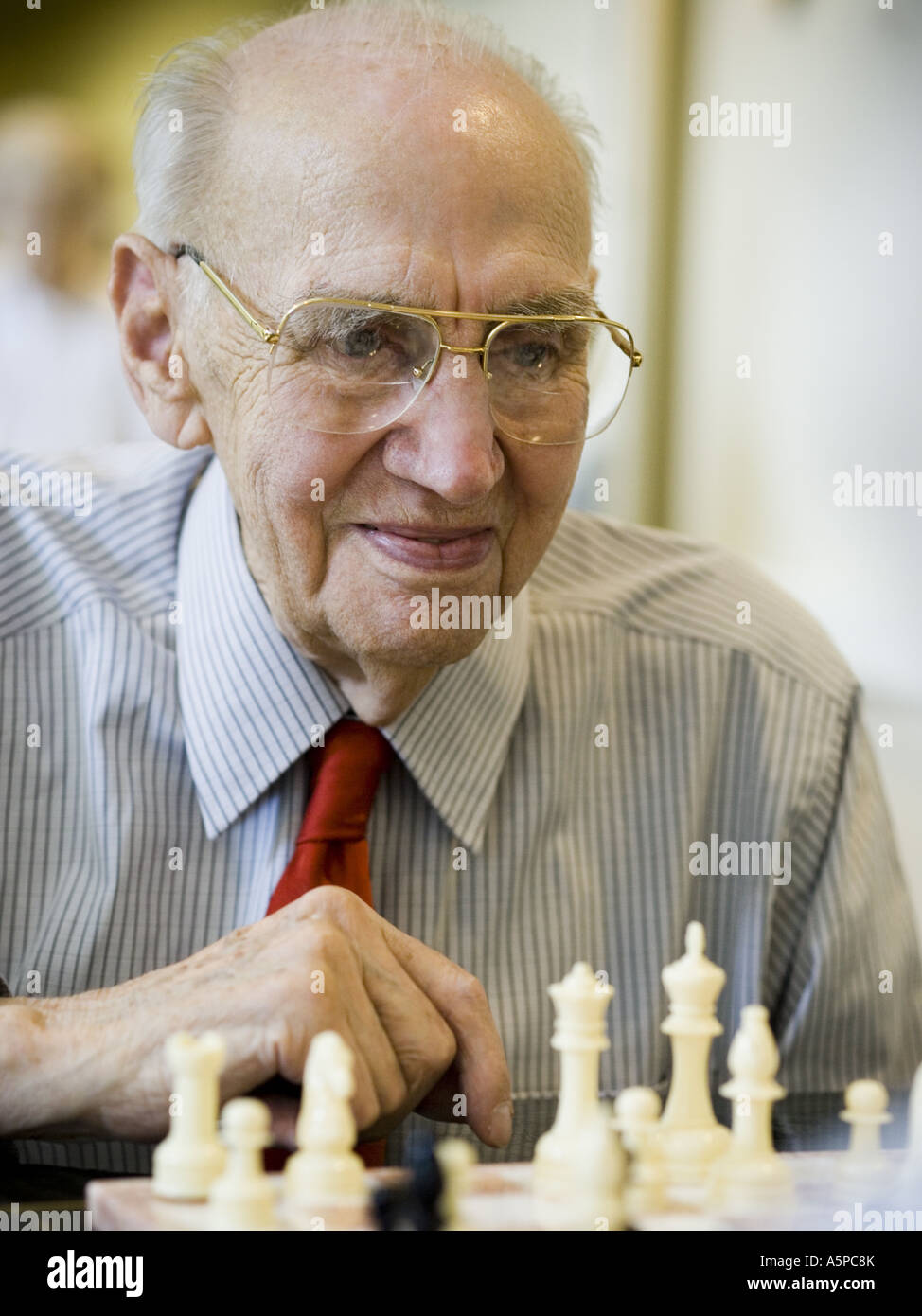 Elderly man playing chess Stock Photo - Alamy