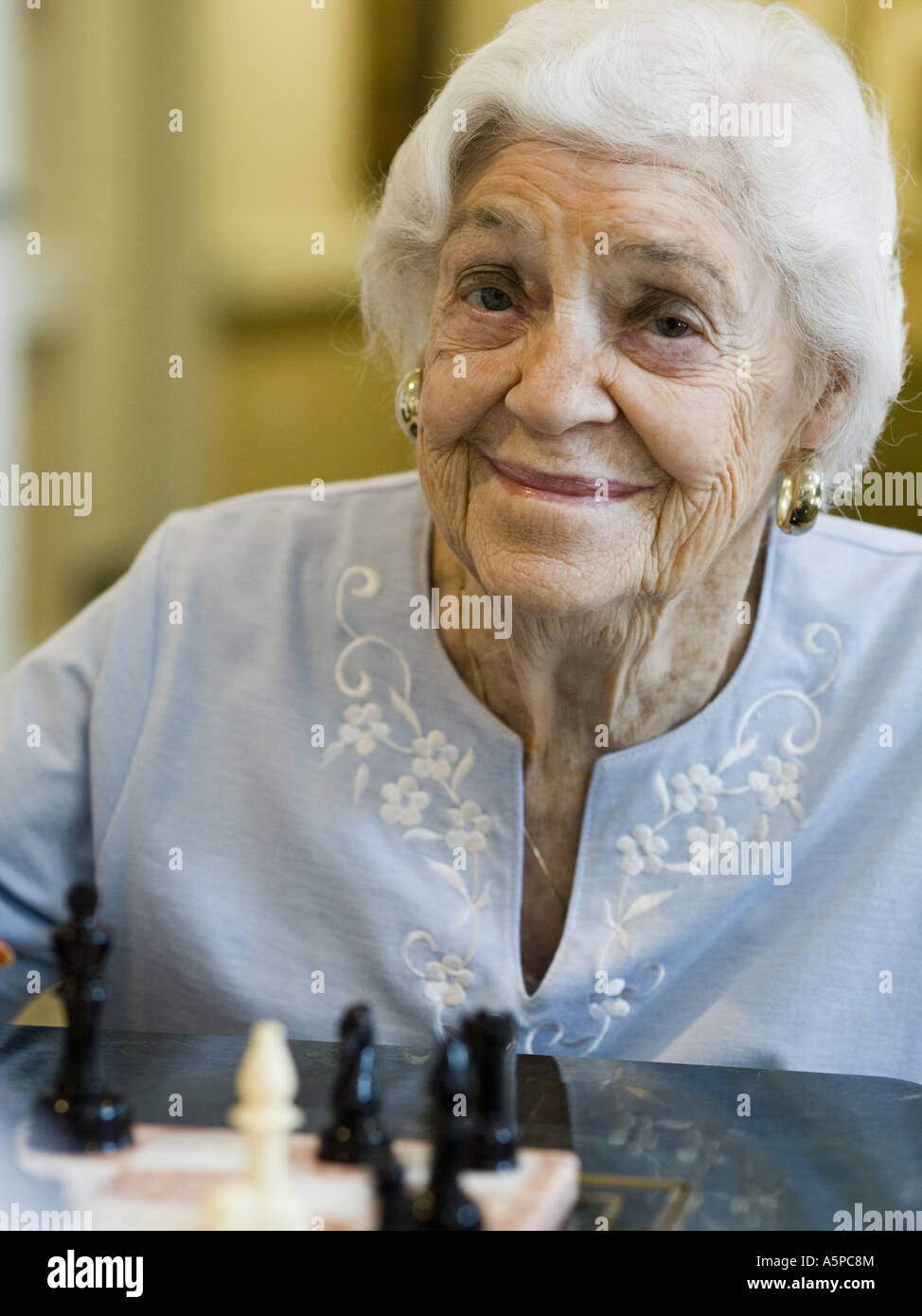 Elderly woman playing chess Stock Photo - Alamy