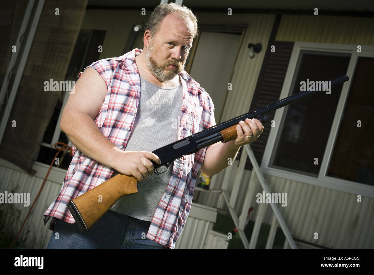 Overweight man with a shotgun Stock Photo - Alamy