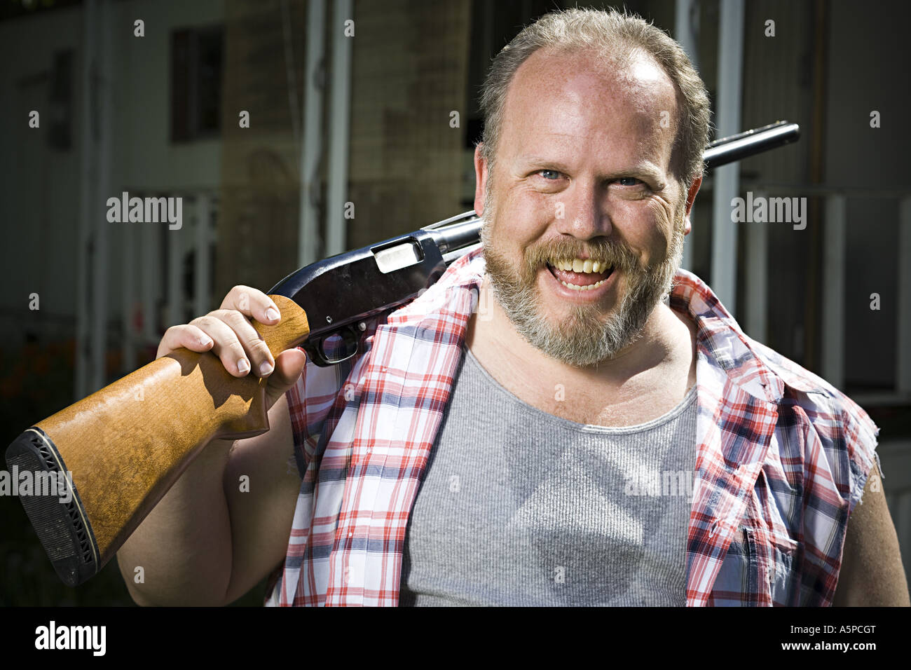 Overweight man with a shotgun Stock Photo - Alamy