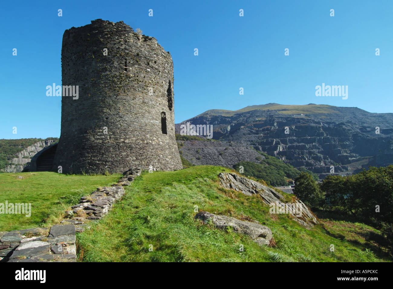 The ruins of Dolbadarn Castle with old slate quarry workings beyond ...