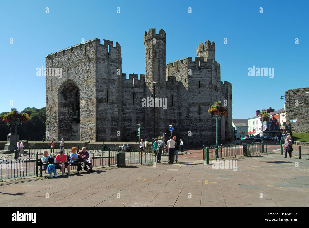 Tourists & locals on blue sky day in Welsh Castle Square with ...