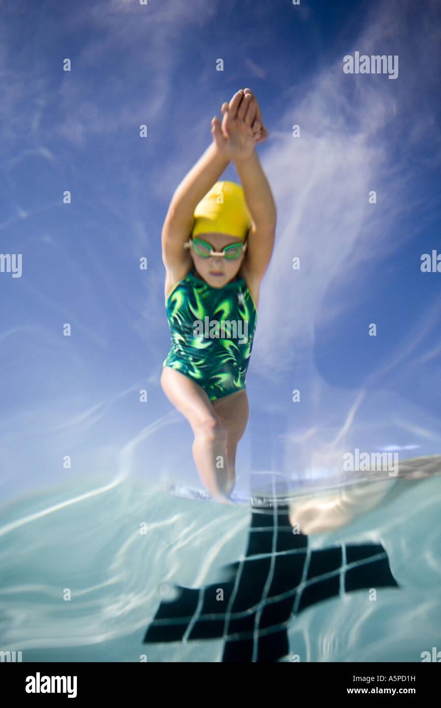 Girl diving into swimming pool Stock Photo - Alamy