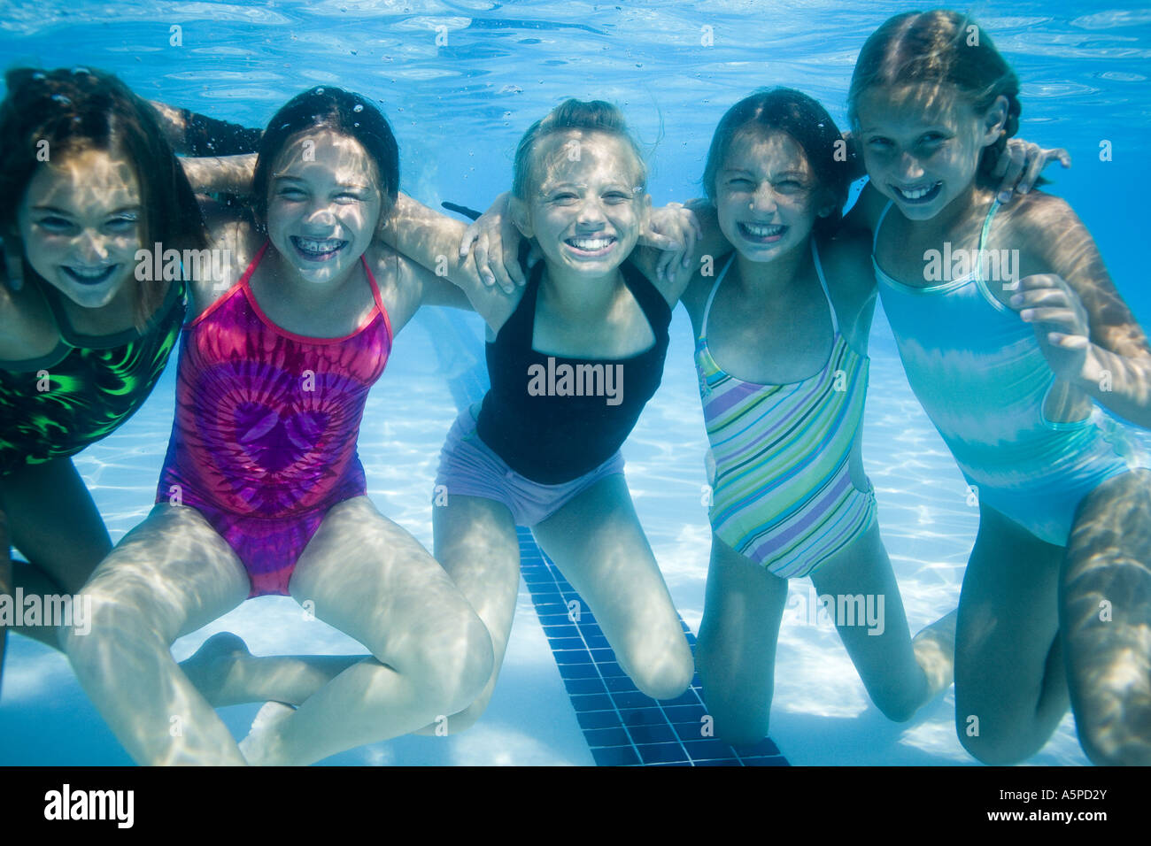 Girls swimming underwater in pool Stock Photo - Alamy