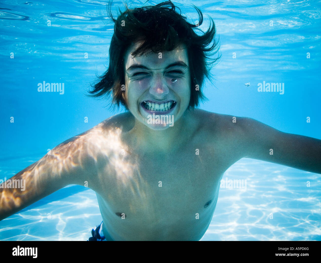 Boy swimming underwater in pool Stock Photo - Alamy