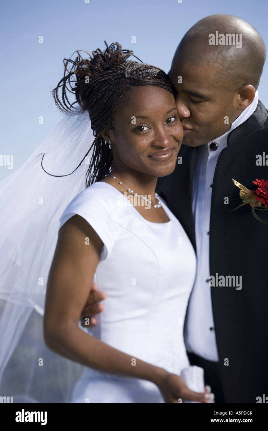 Close-up of a groom kissing his bride Stock Photo - Alamy