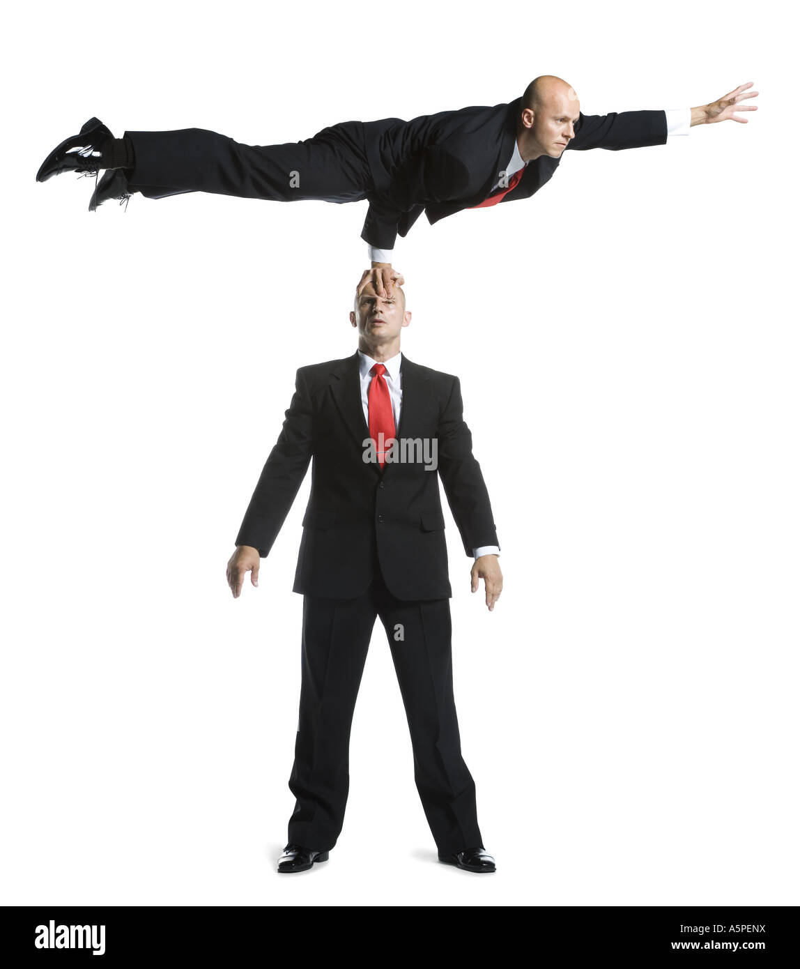 Two male acrobats in business suits performing Stock Photo - Alamy