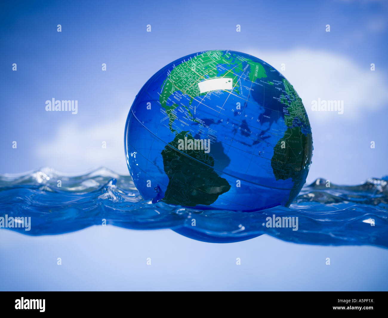 Earth globe floating in water Stock Photo - Alamy