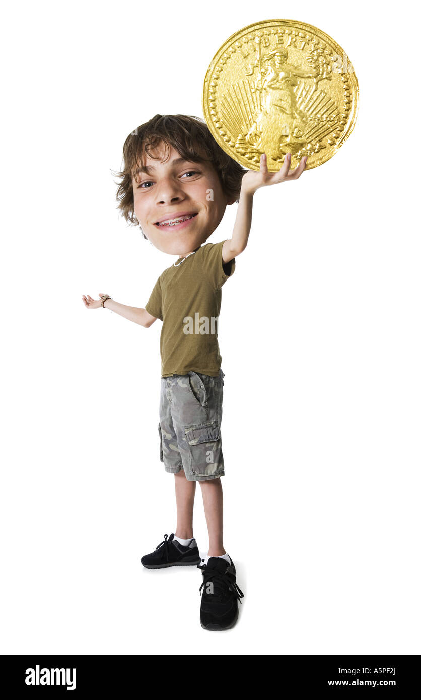 Teenage boy holding a US gold coin Stock Photo - Alamy