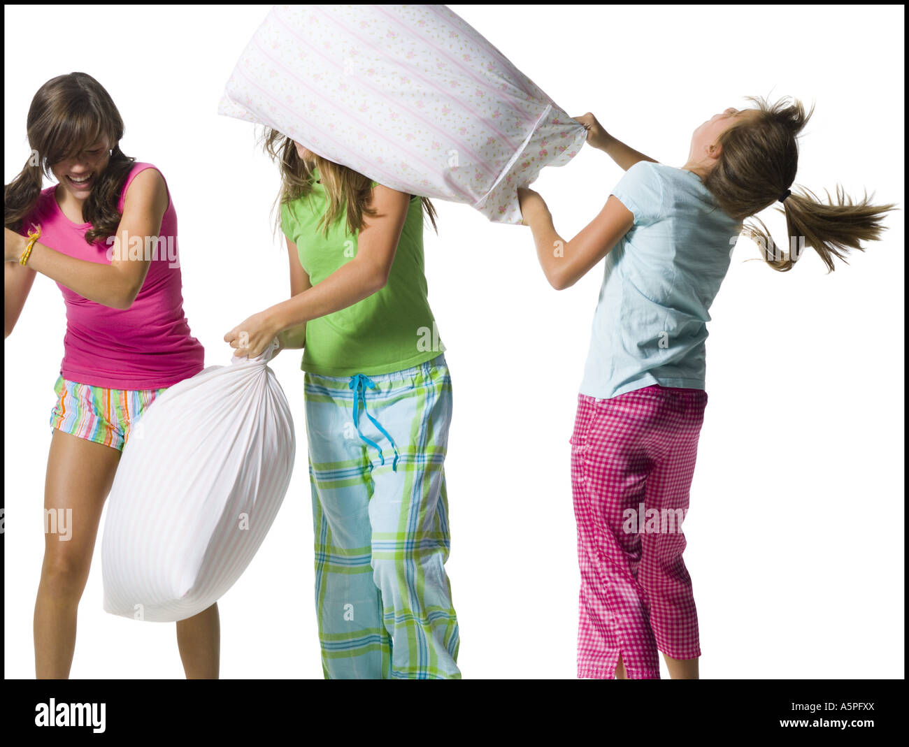 Three girls pillow fighting Stock Photo - Alamy