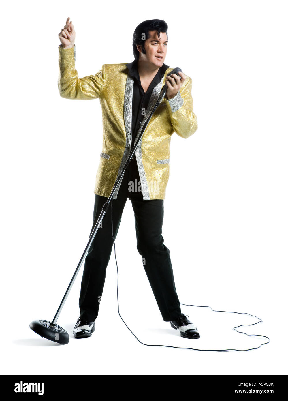 An Elvis impersonator singing into a microphone Stock Photo - Alamy