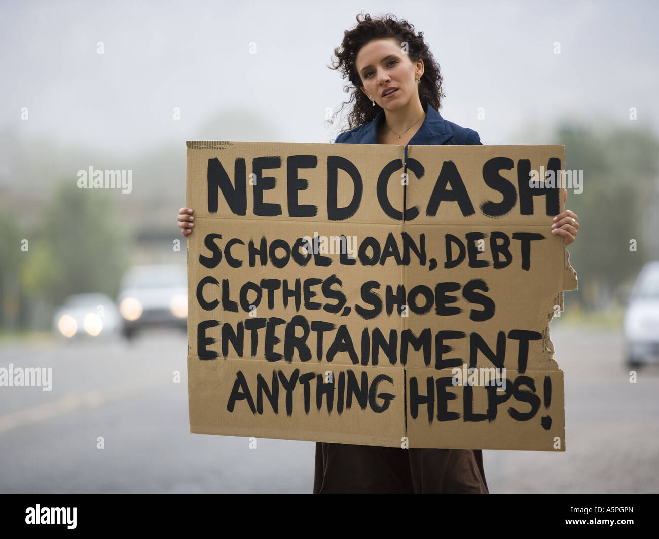A young woman holding a help needed sign Stock Photo - Alamy