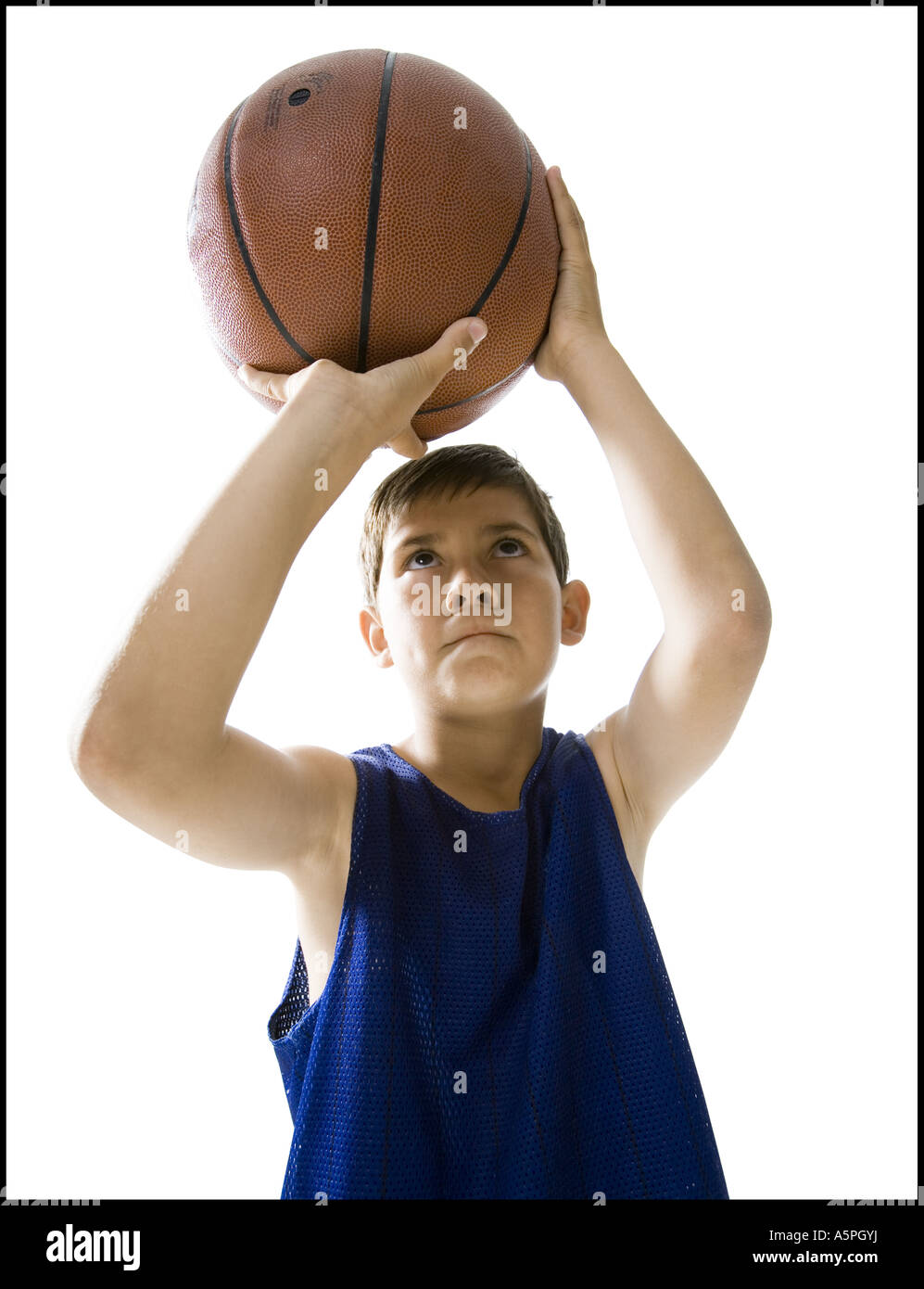 Boy playing basketball and taking a shot Stock Photo - Alamy
