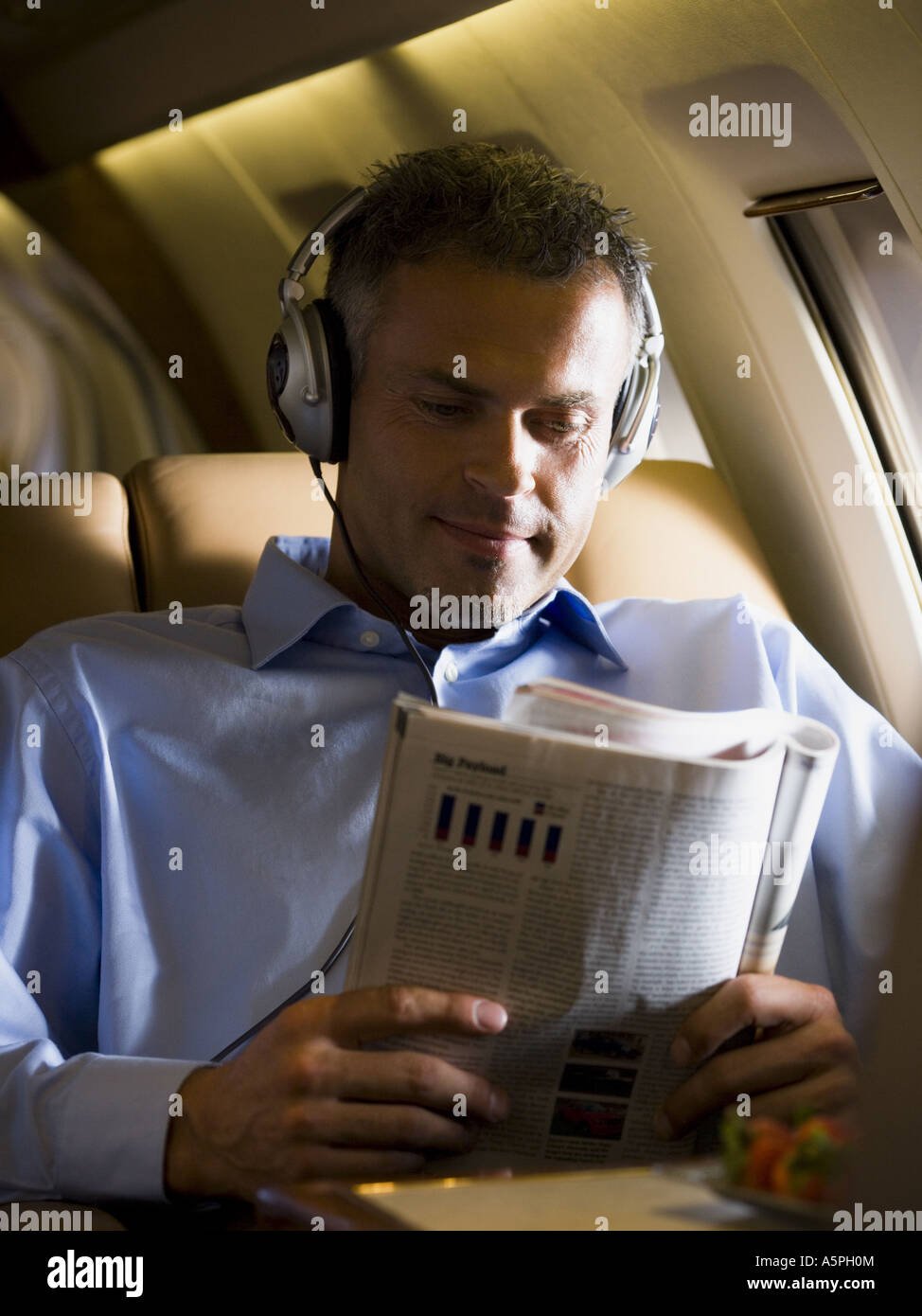 A senior man reading a magazine in an airplane Stock Photo - Alamy