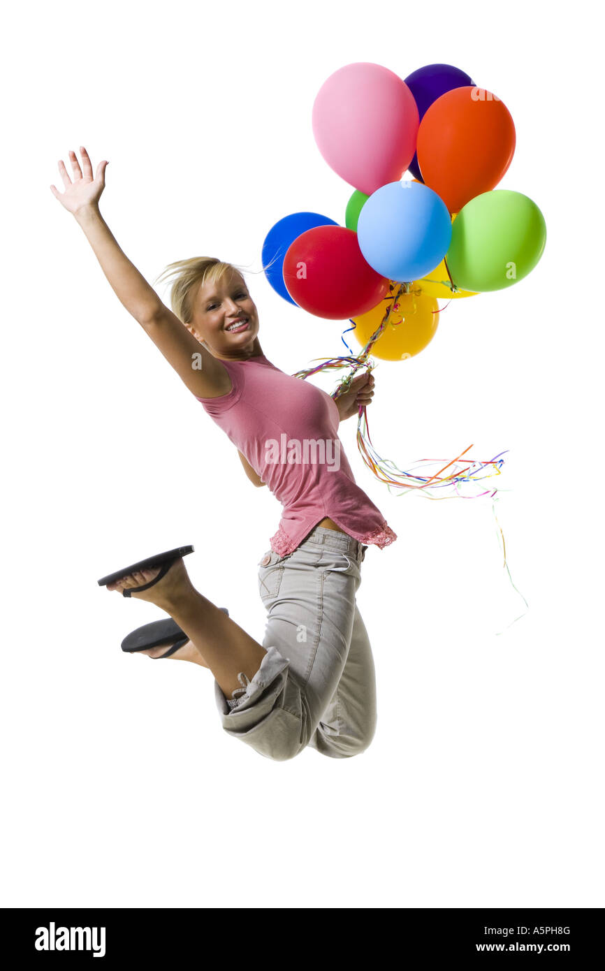 Woman with balloons jumping Stock Photo - Alamy