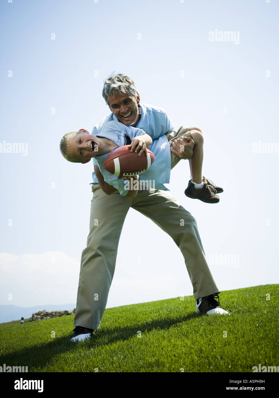 Portrait of a man carrying his son Stock Photo - Alamy