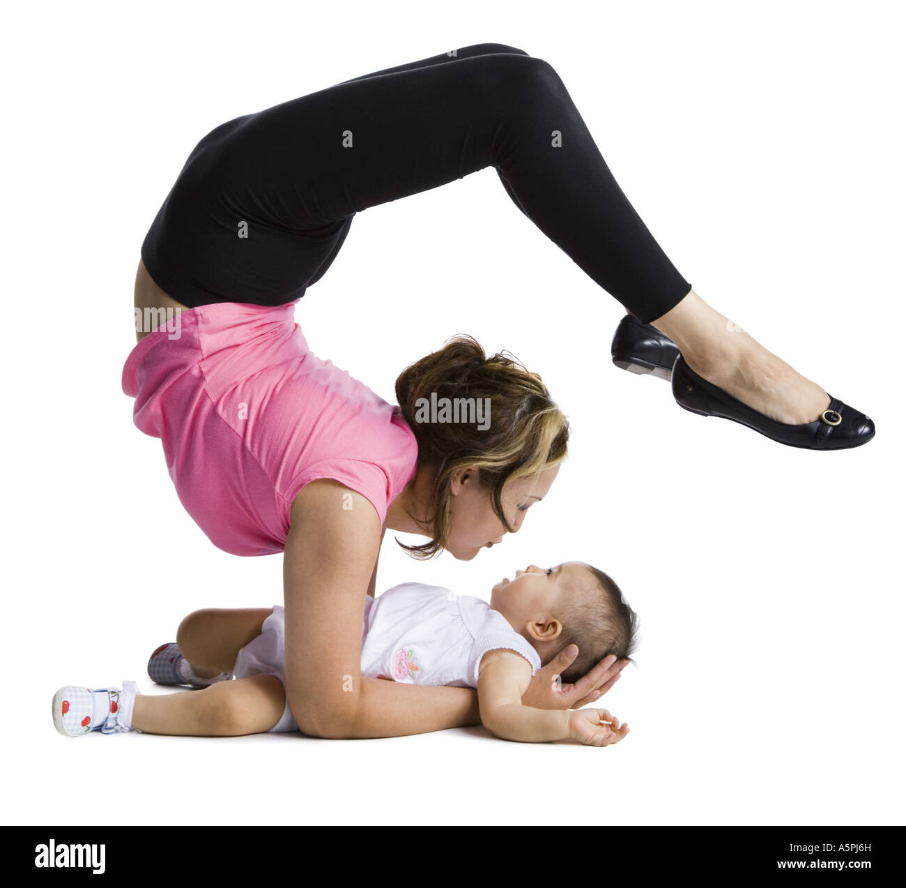 Contortionist mother with baby daughter Stock Photo - Alamy