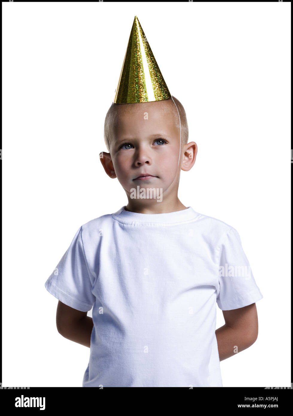 Young boy with party hat holding hands behind back Stock Photo - Alamy