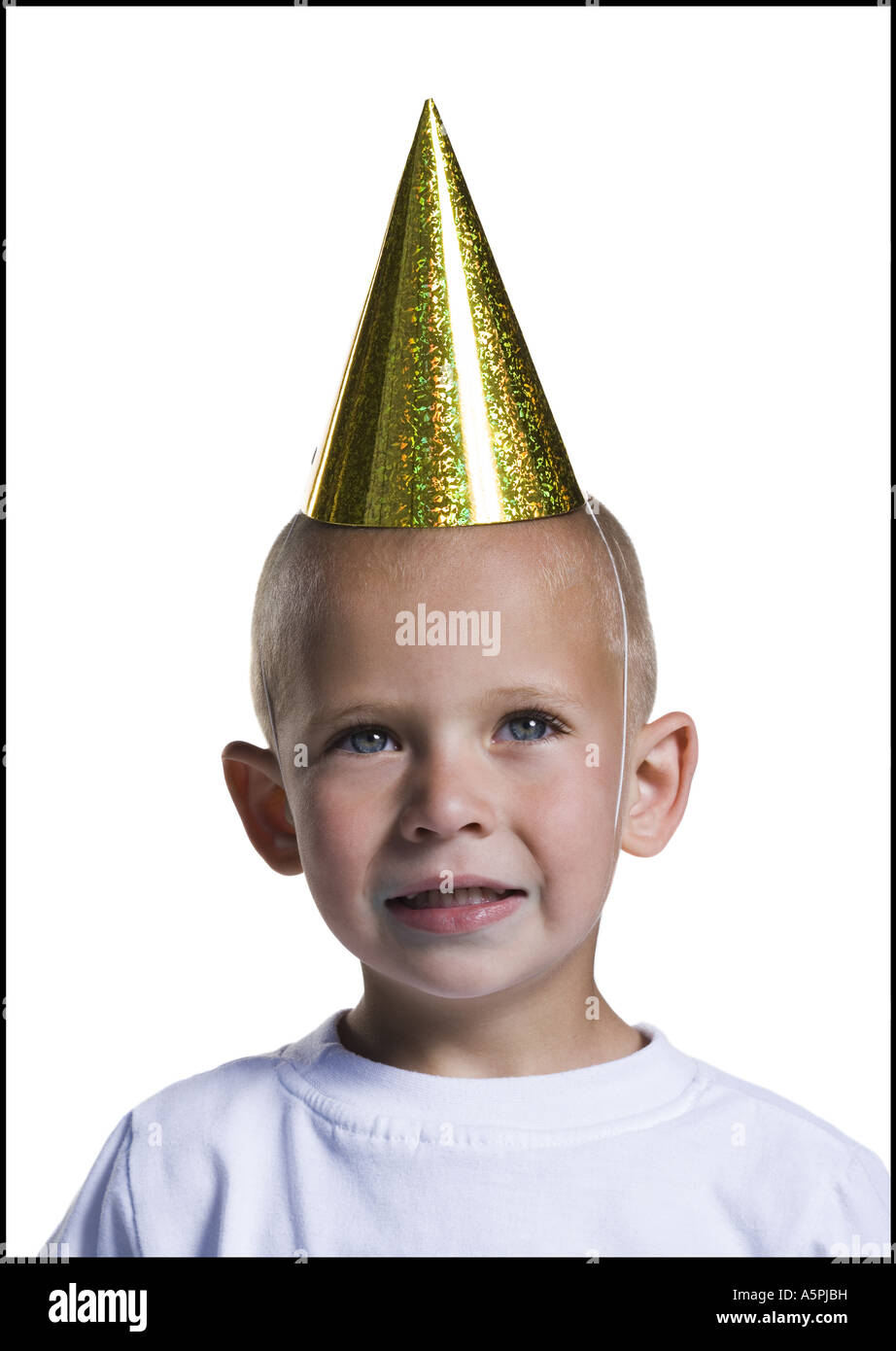 Young boy with party hat holding hands behind back Stock Photo - Alamy