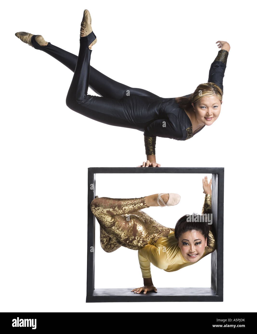 Female contortionist duo with box prop Stock Photo - Alamy