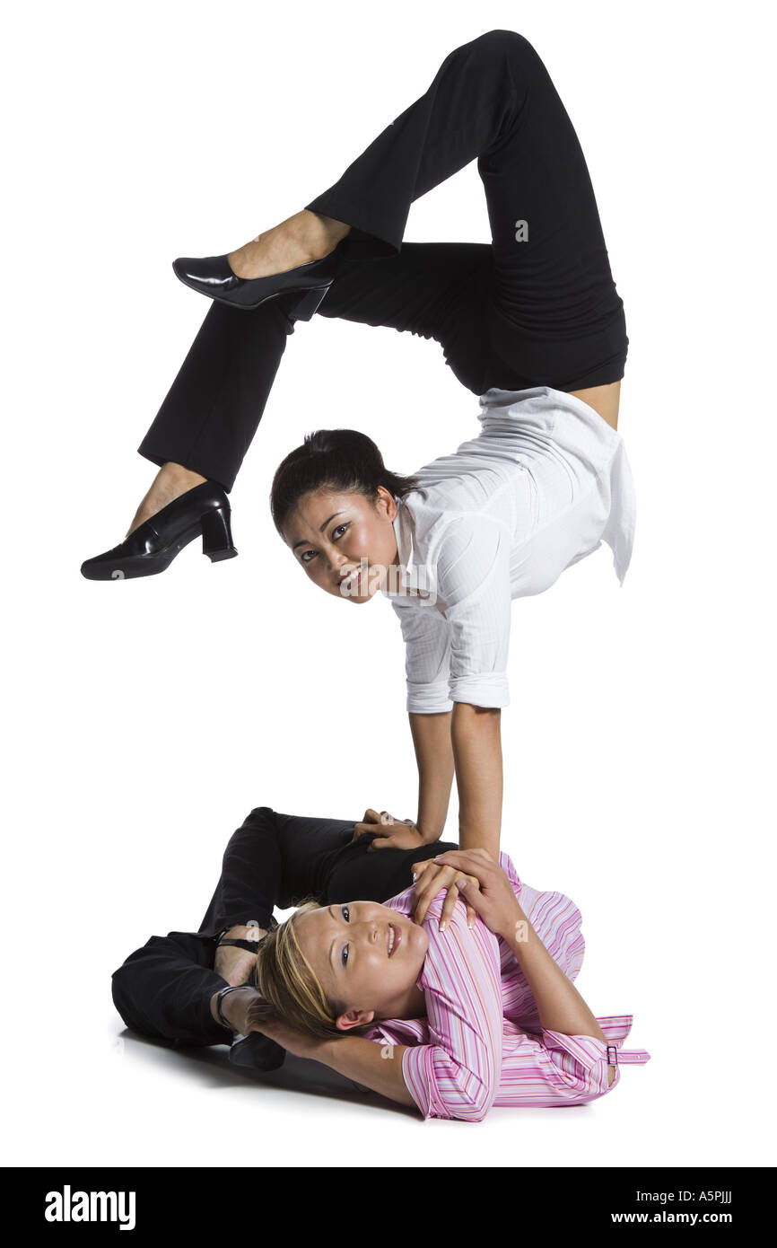 Two female contortionist businesswomen Stock Photo - Alamy