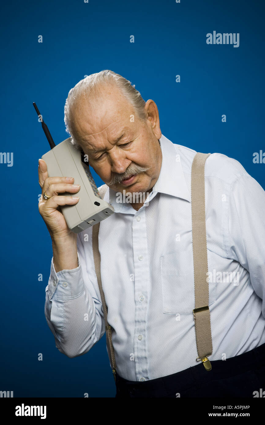 Older man making call on retro wireless phone Stock Photo - Alamy