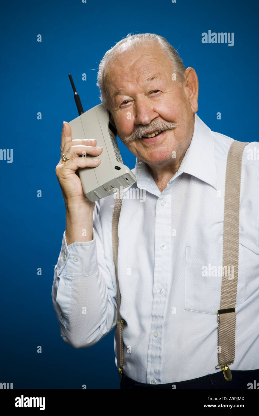 Older man making call on retro wireless phone Stock Photo - Alamy