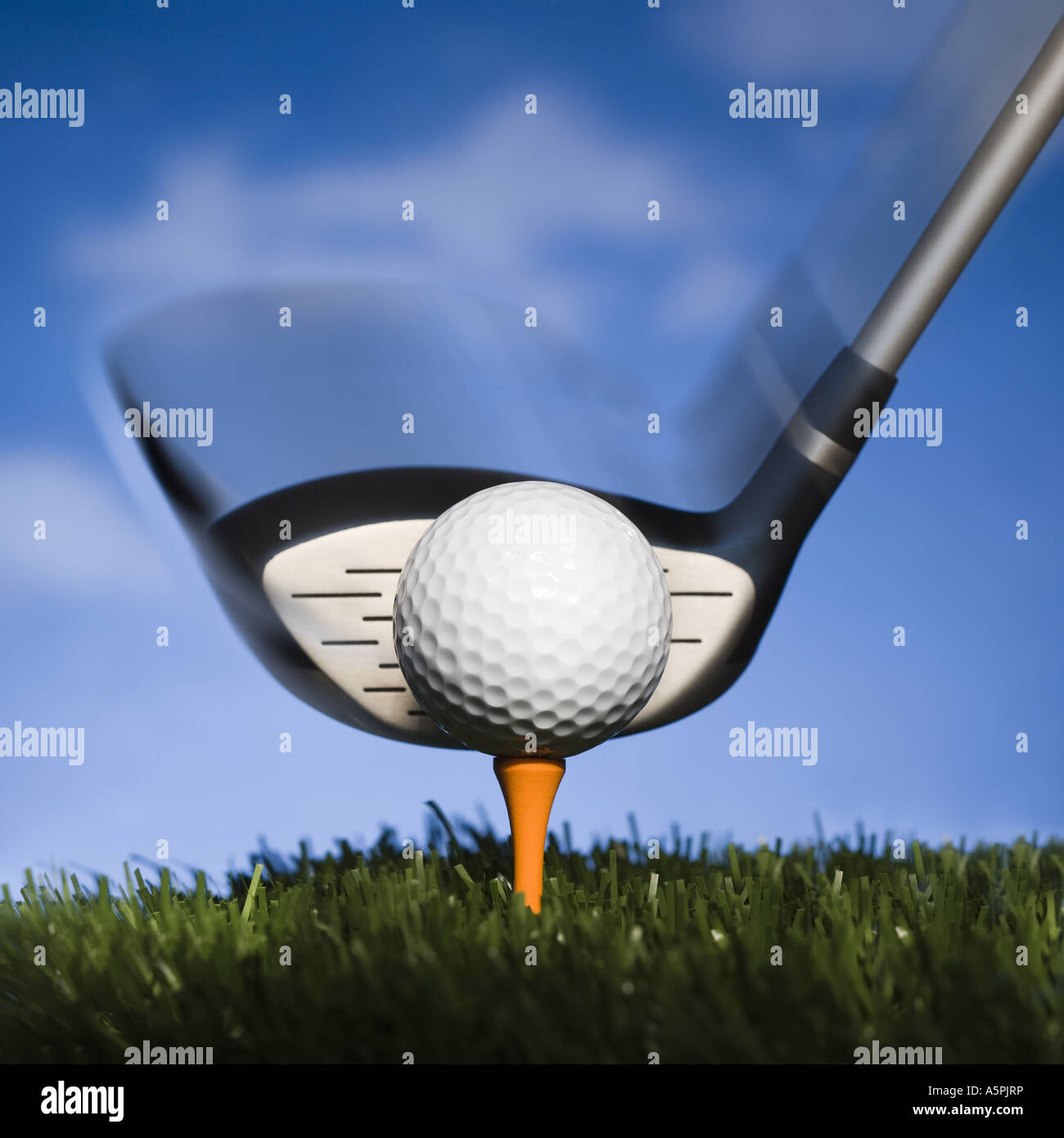Golf club hitting golfball off tee Stock Photo - Alamy