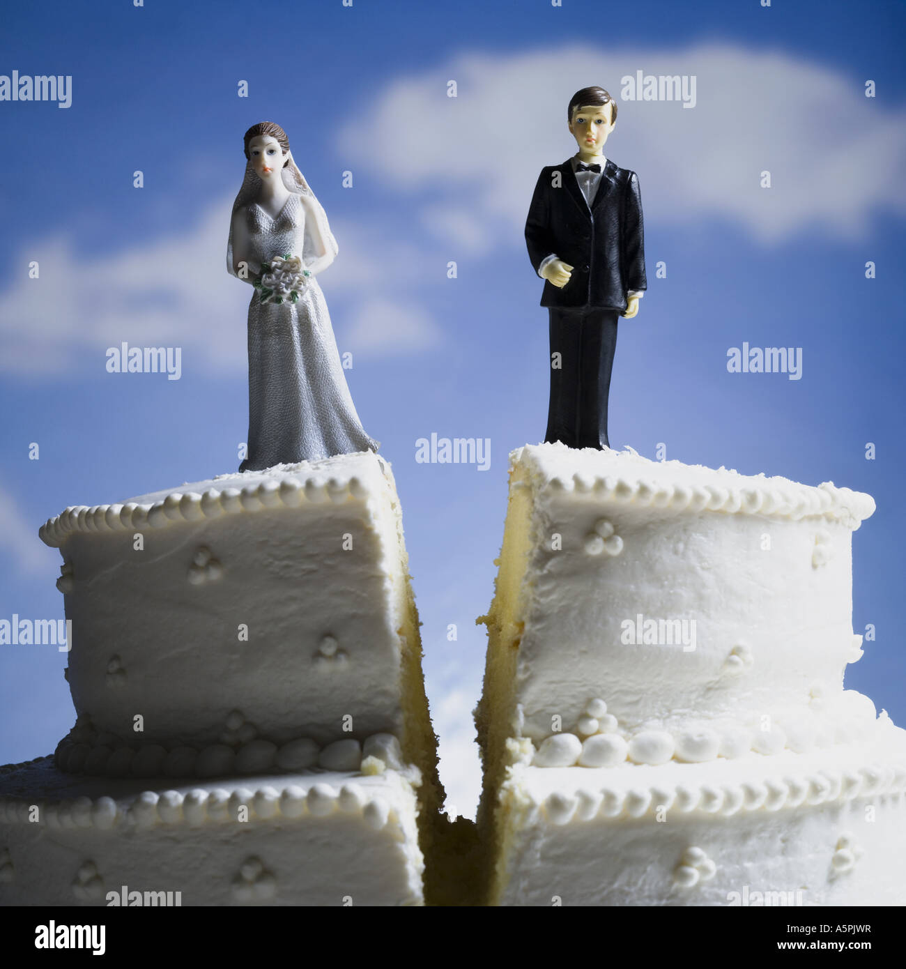 Wedding cake visual metaphor with figurine cake toppers Stock Photo - Alamy