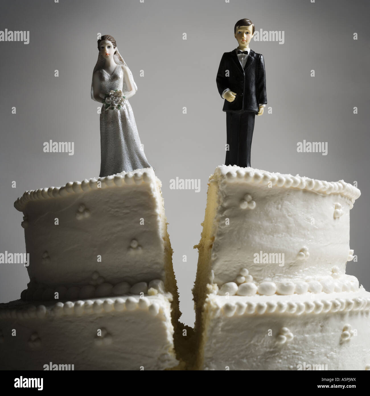 Wedding cake visual metaphor with figurine cake toppers Stock Photo - Alamy
