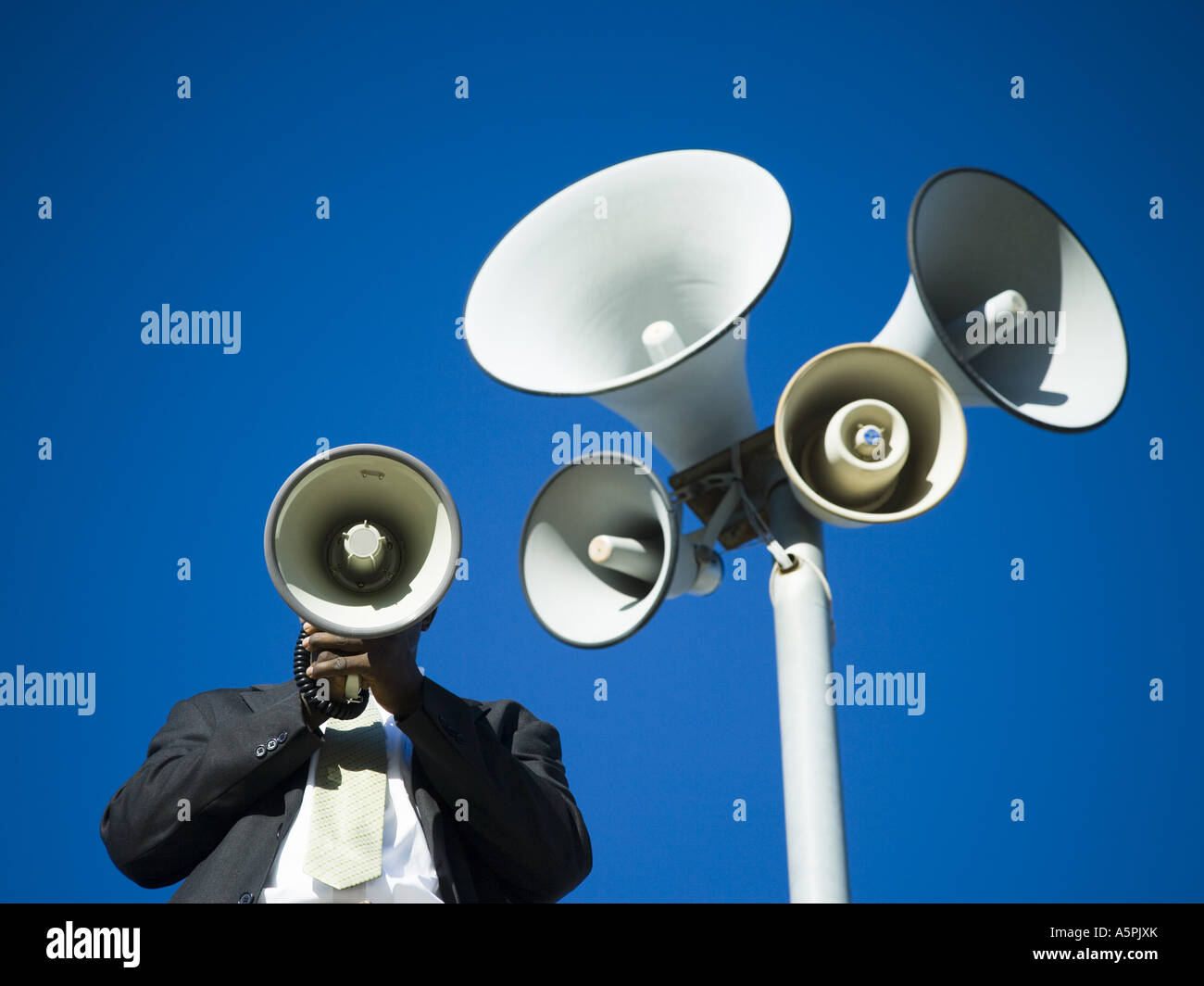 Man yelling through bullhorn Stock Photo - Alamy