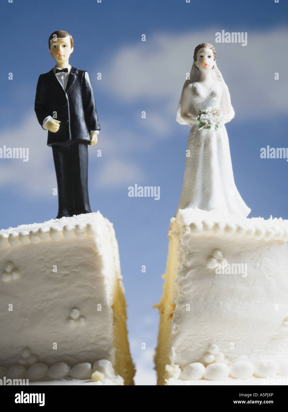 Wedding cake visual metaphor with figurine cake toppers Stock Photo - Alamy