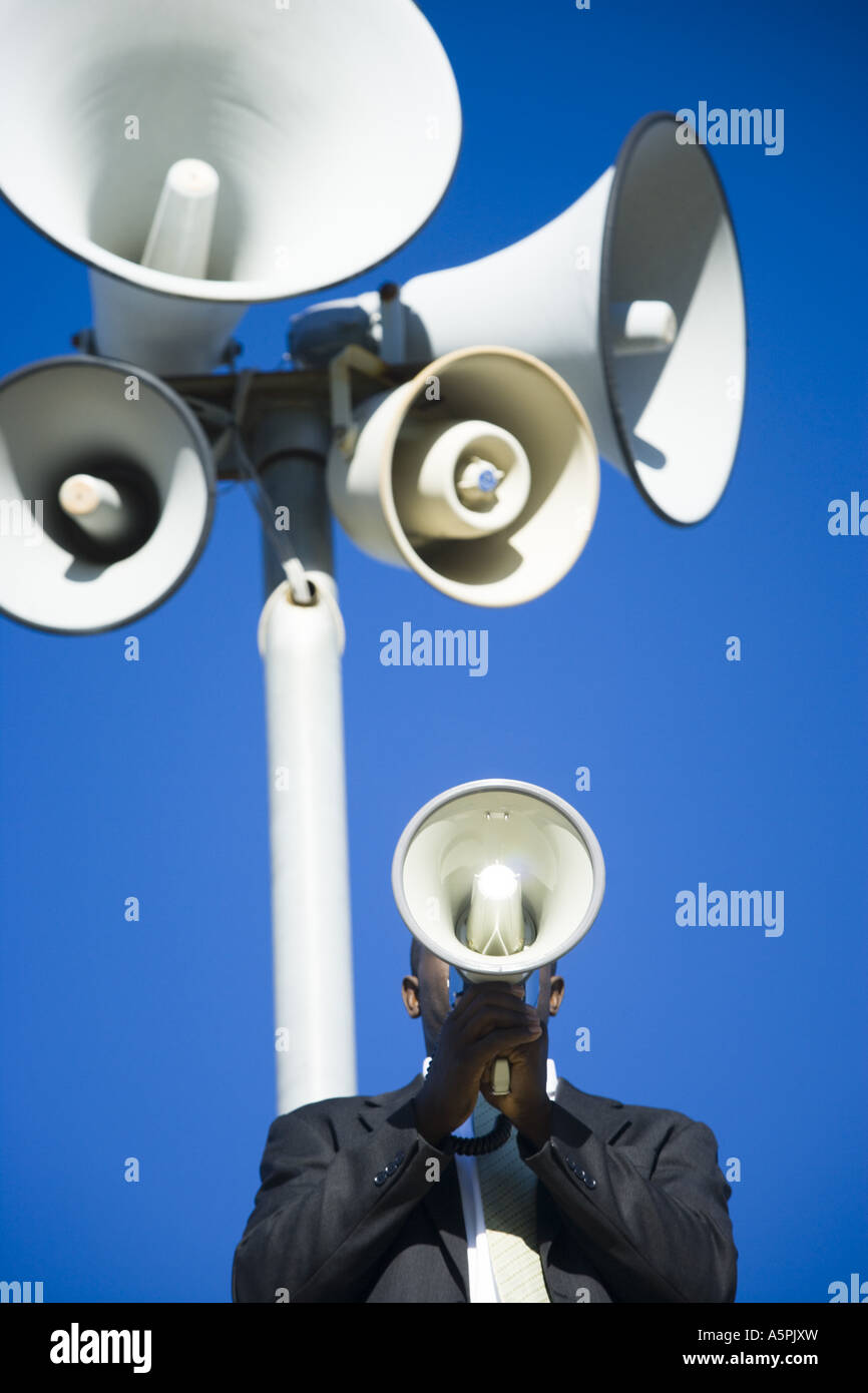 Man yelling through bullhorn Stock Photo - Alamy