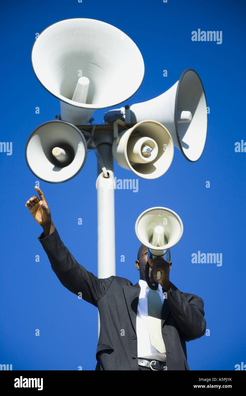 Man yelling through bullhorn Stock Photo - Alamy