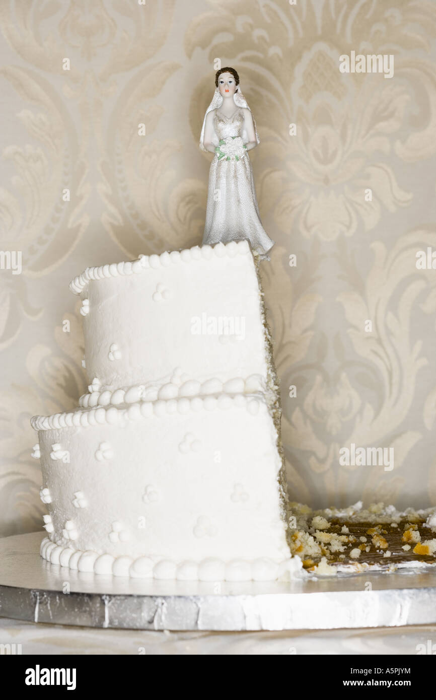 Wedding cake visual metaphor with figurine cake toppers Stock Photo - Alamy