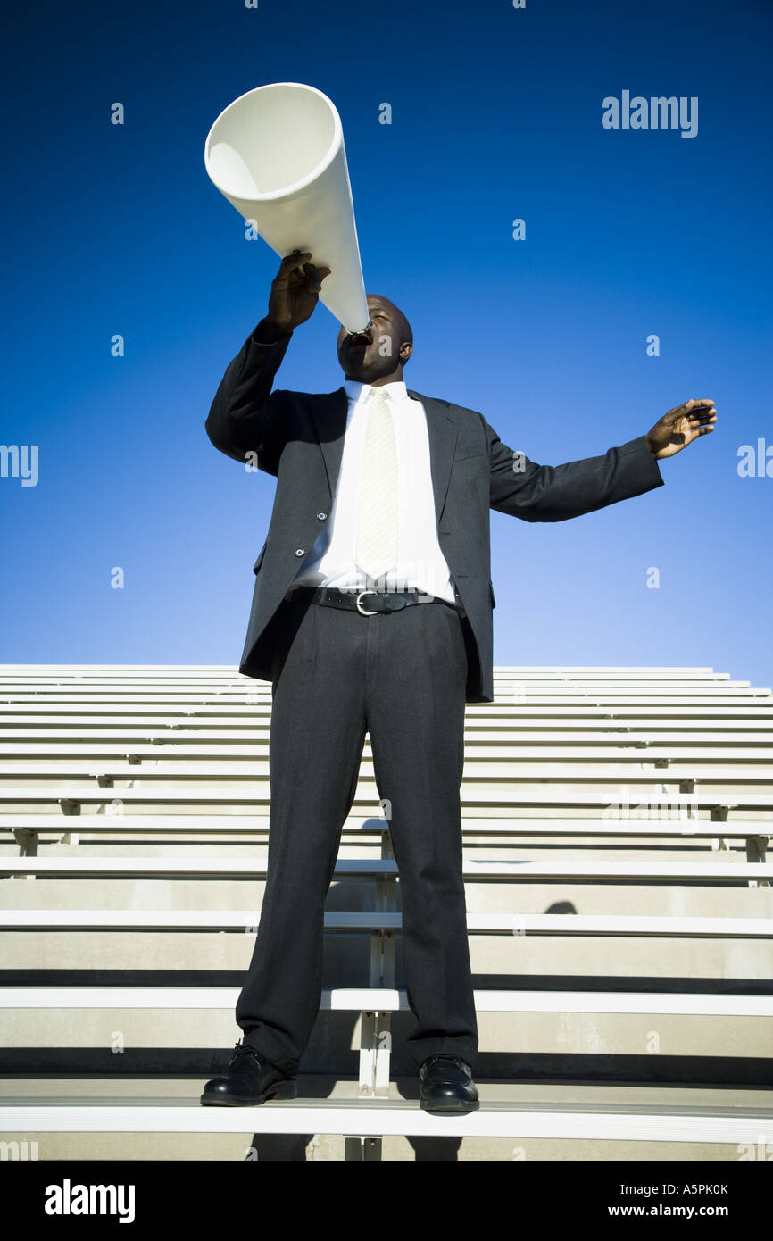 Man yelling through bullhorn Stock Photo - Alamy