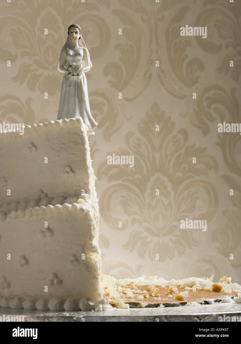 Wedding cake visual metaphor with figurine cake toppers Stock Photo - Alamy