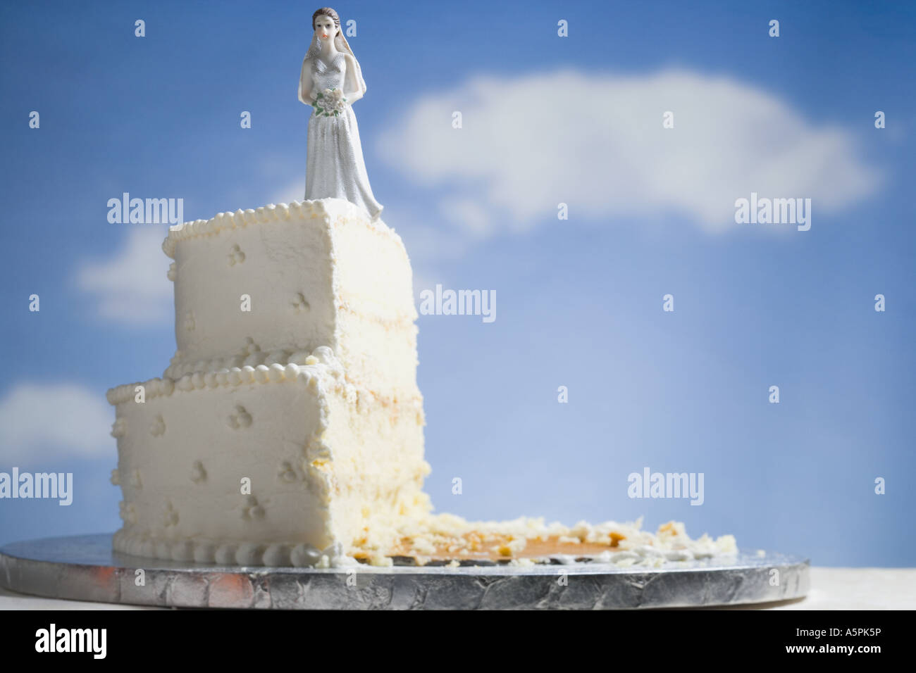 Wedding cake visual metaphor with figurine cake toppers Stock Photo - Alamy