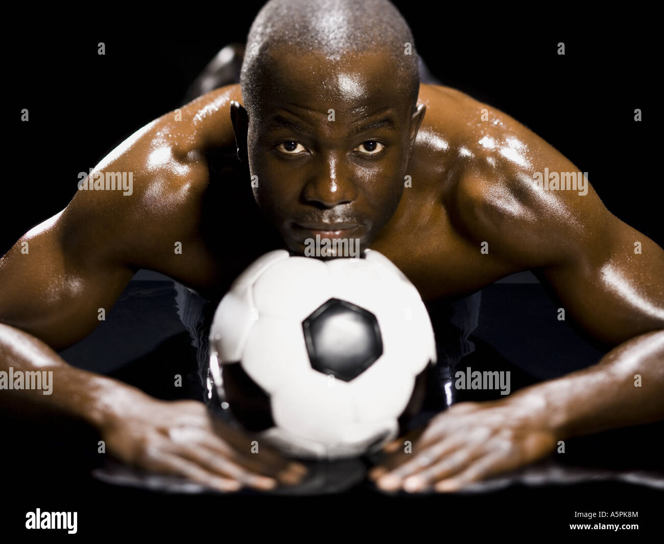 Athlete posing with soccer ball Stock Photo - Alamy