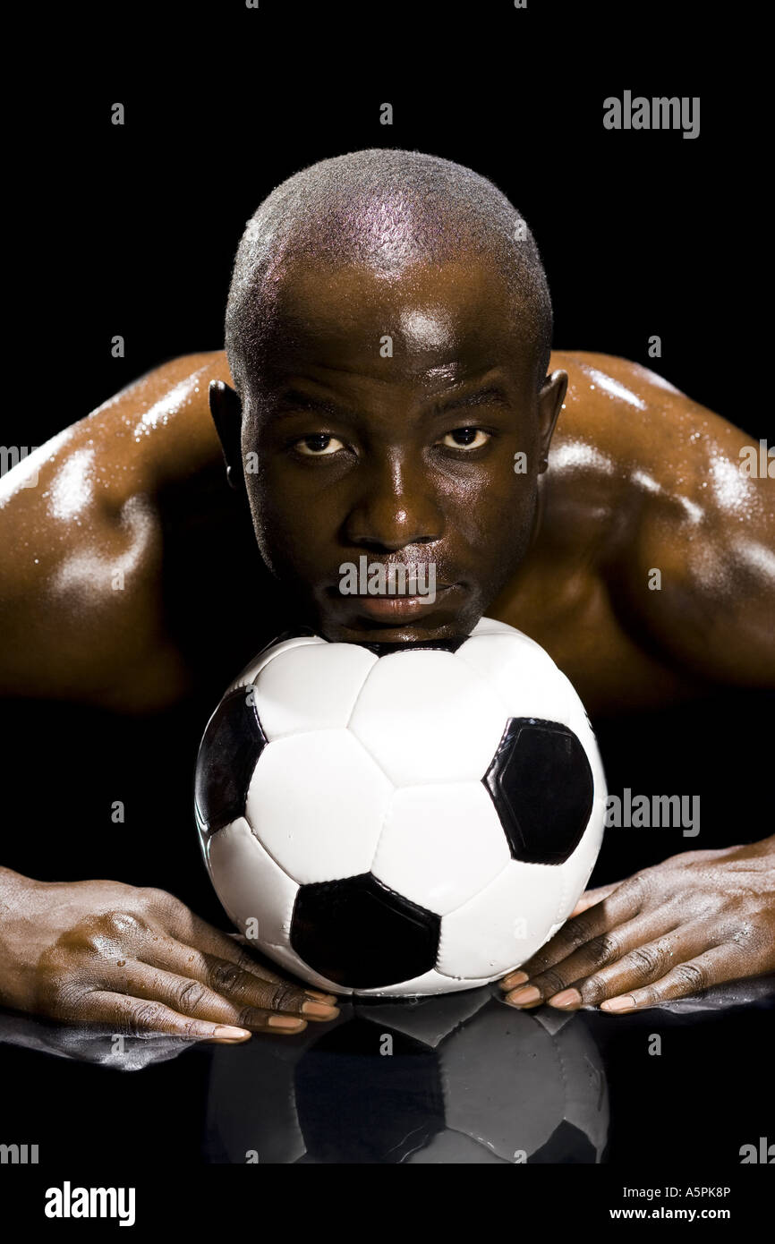 Athlete posing with soccer ball Stock Photo - Alamy
