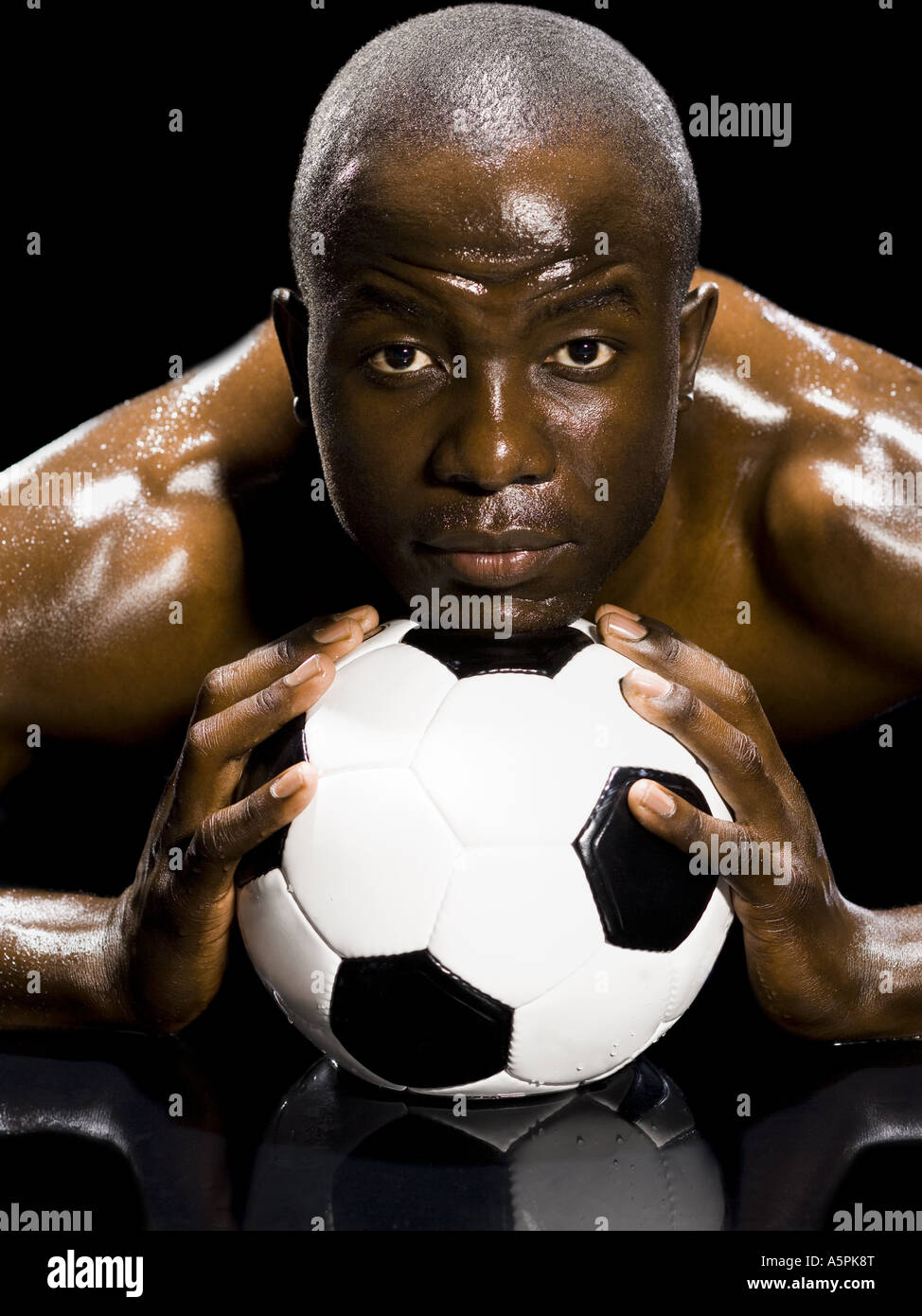 Athlete posing with soccer ball Stock Photo - Alamy