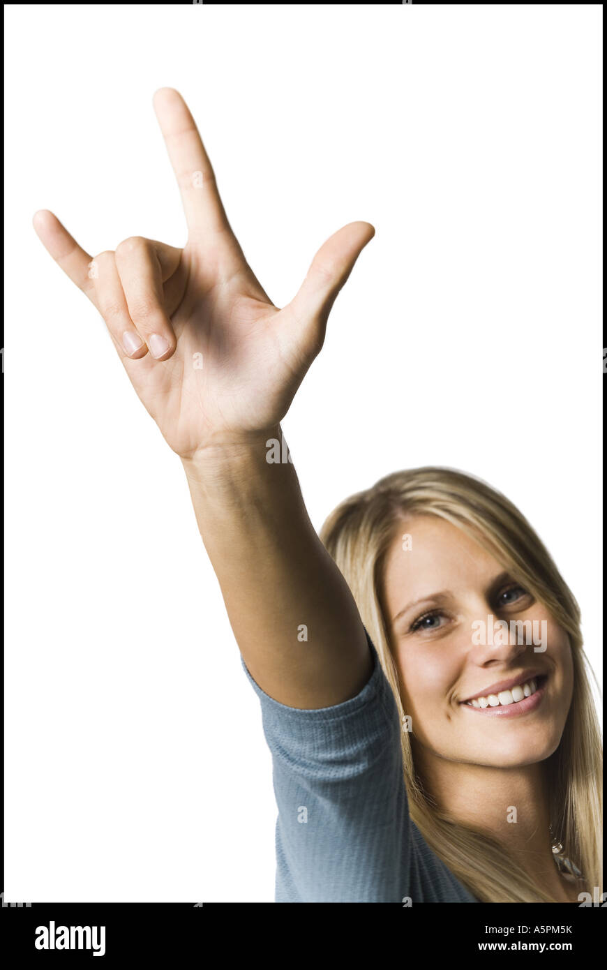 Woman making the i love you sign Stock Photo - Alamy